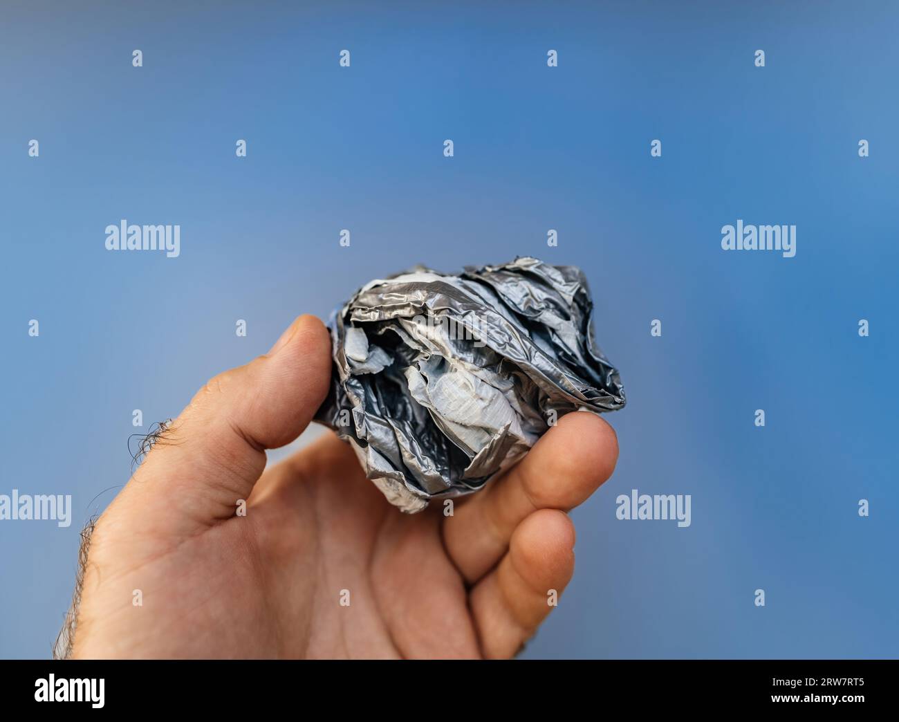 male hand grips a roll of Scotch tape with reinforced textile inside ...