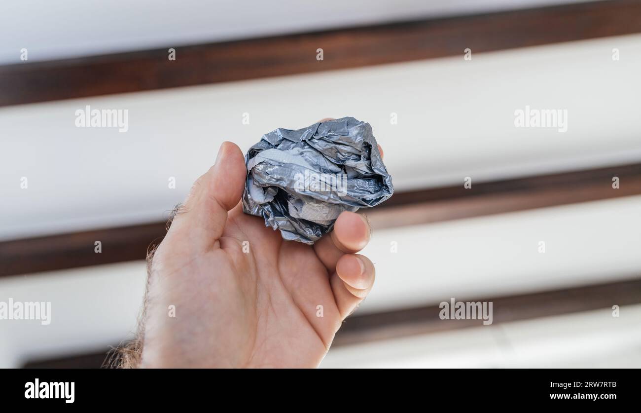 A male hand grips a roll of plastic Scotch tape with reinforced textile ...