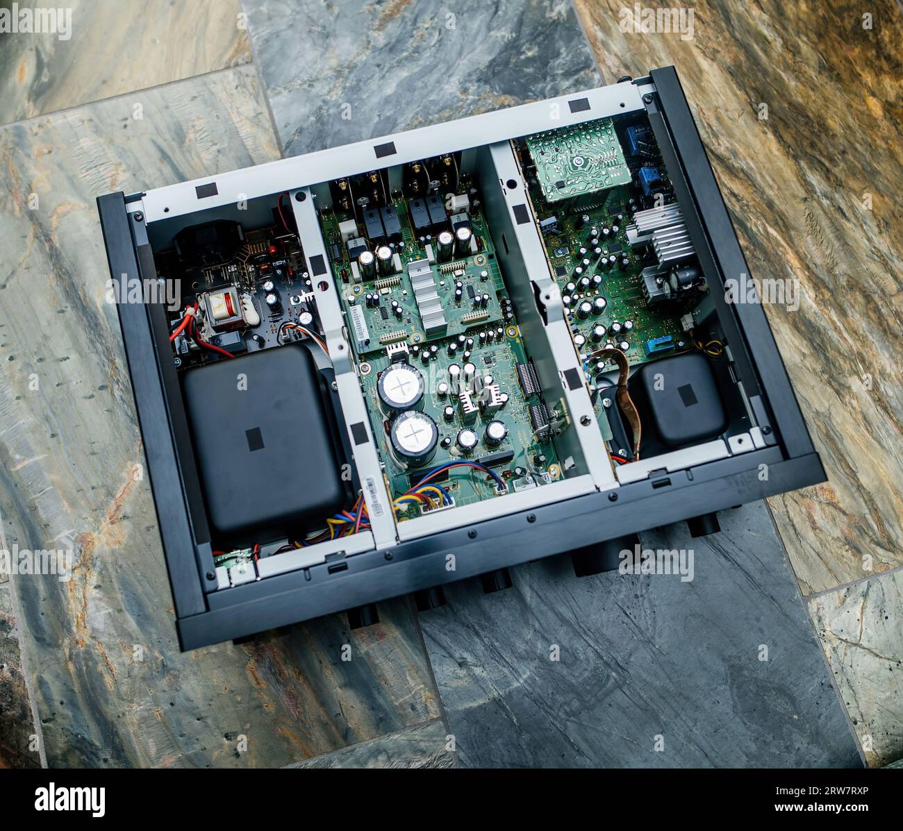 Open metallic lid on a new Hi-Fi Class D amplifier unveils a complex ...