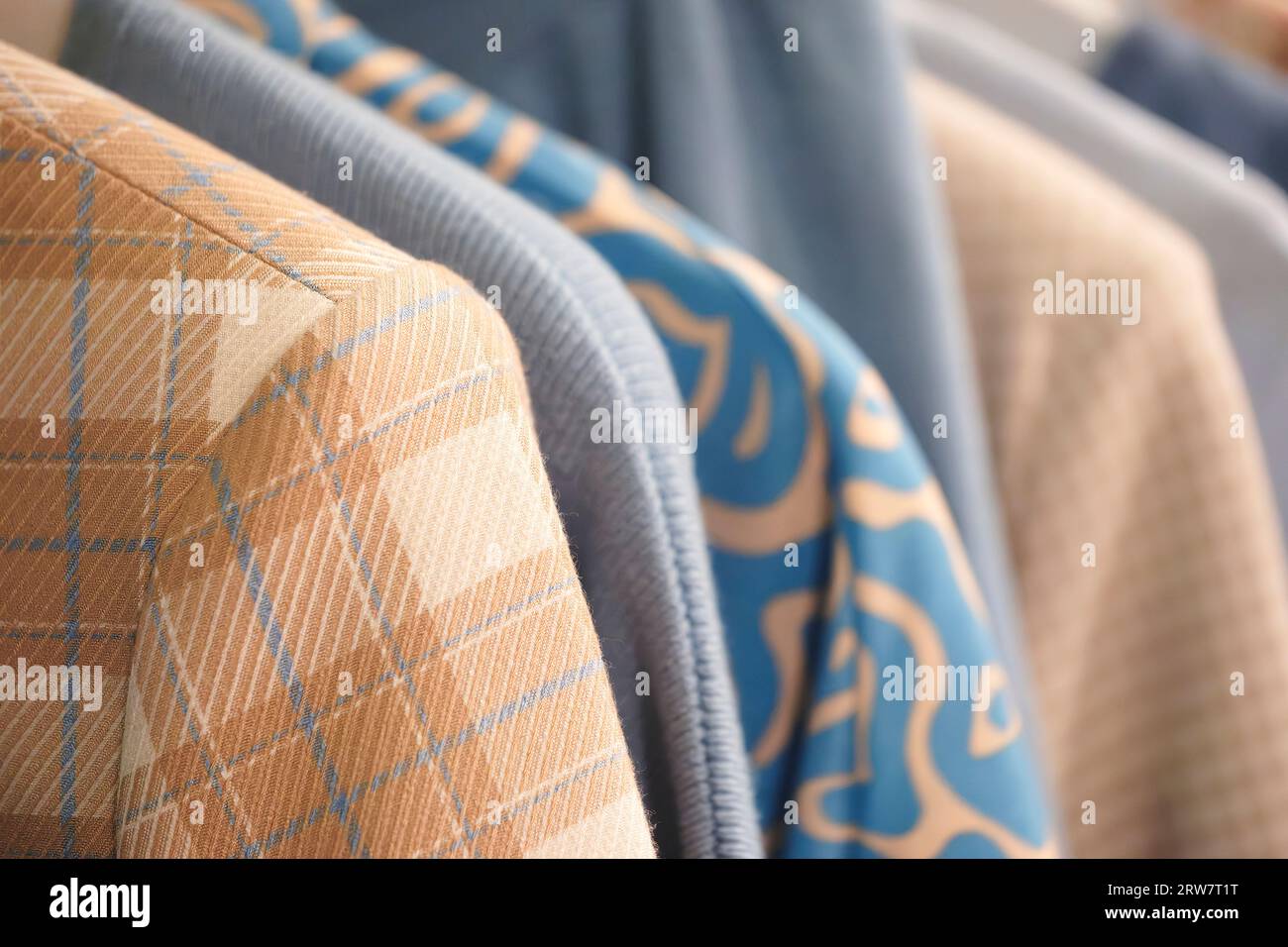 Fashion clothes on clothing rack Closeup of rainbow color choice female ...