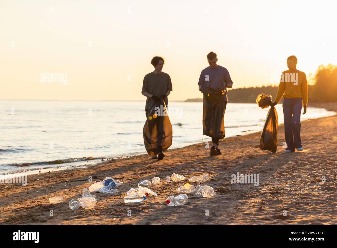 Earth day. Volunteers activists team collects garbage cleaning of beach ...