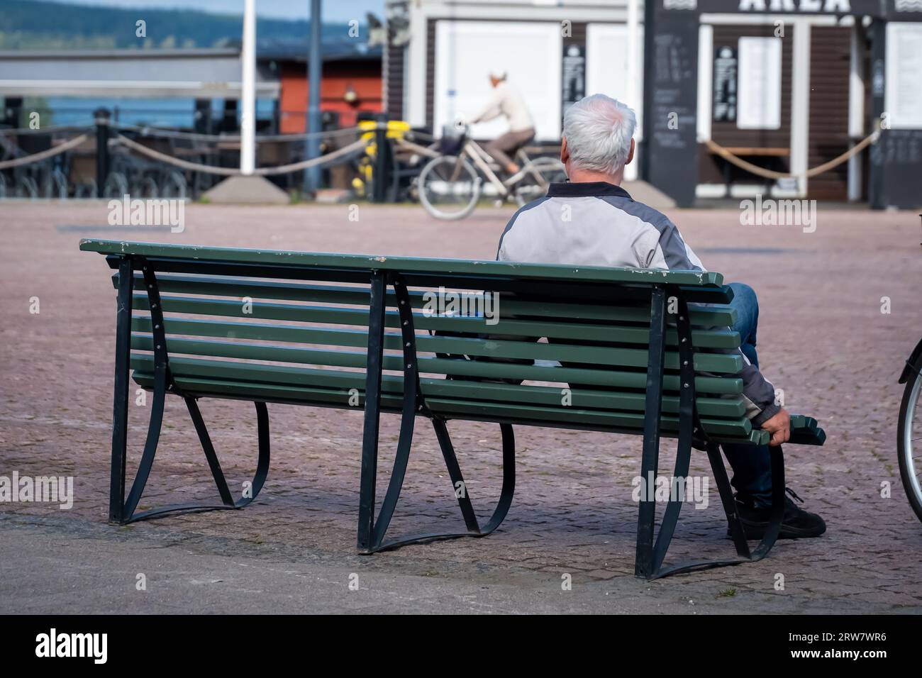 an old man sitting alone on a bench Stock Photo - Alamy