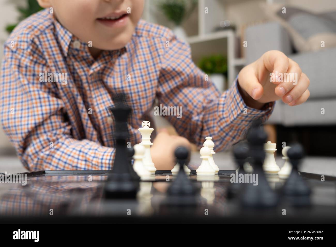 Little boy playing chess. Board games for children Stock Photo - Alamy