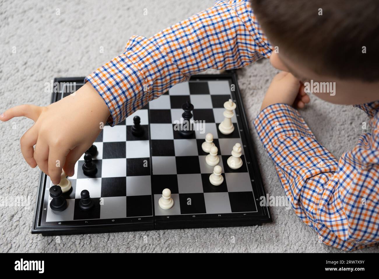 Little boy playing chess. Board games for children Stock Photo - Alamy
