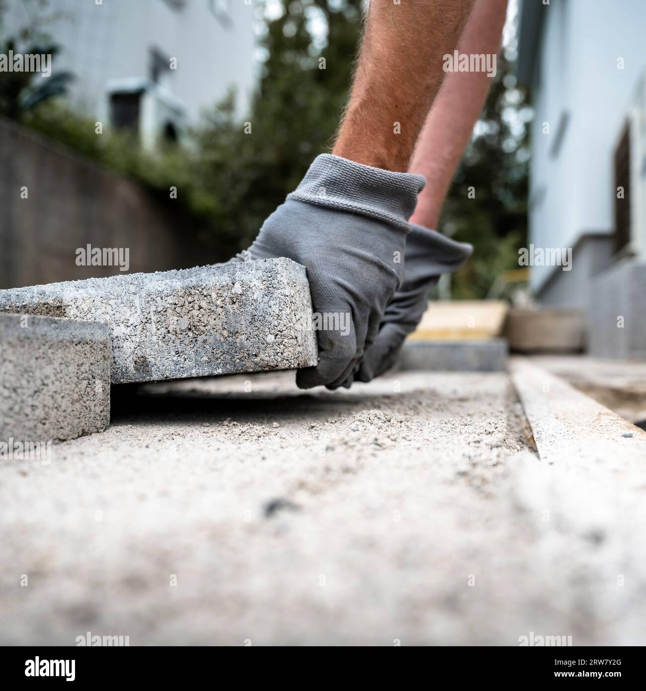 Low angle closeup view of male hands in protective work gloves laying ...