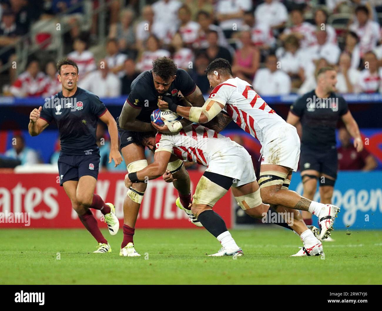England's Courtney Lawes tackled by Japan's Amato Fakatava and Kazuki ...