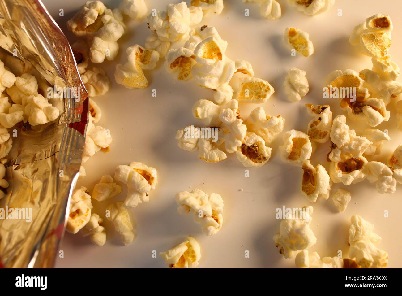 A photo of popcorn snack leaking out of a popcorn packet Stock Photo ...