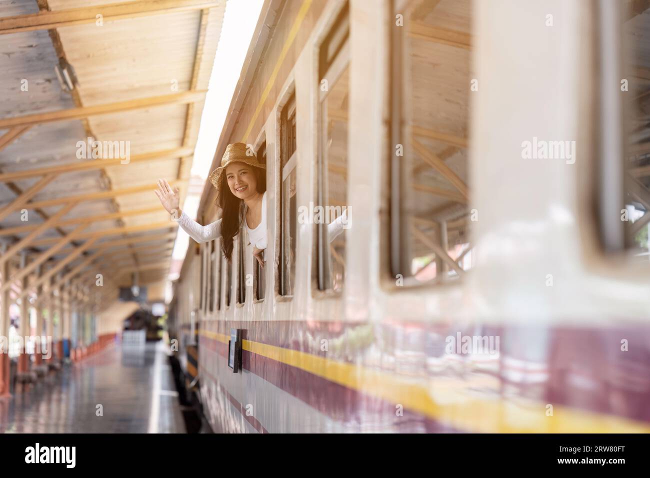 Young woman travelling by train and waving her hand out window Stock ...