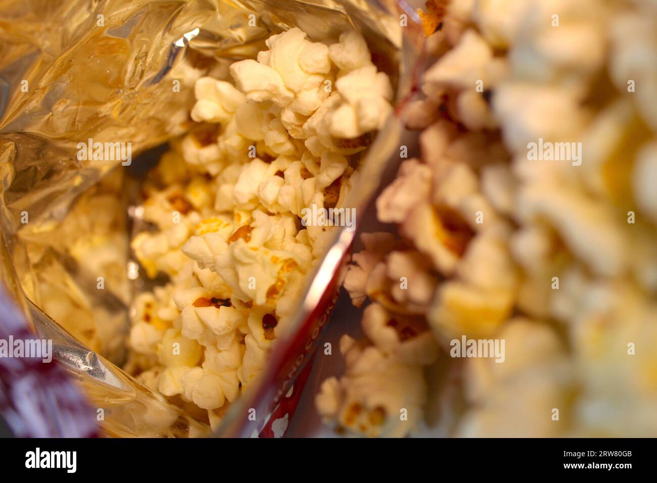 A photo of popcorn snack leaking out of a popcorn packet Stock Photo ...
