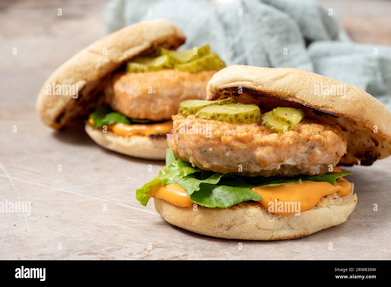 Salmon fishburger on english muffin Stock Photo - Alamy
