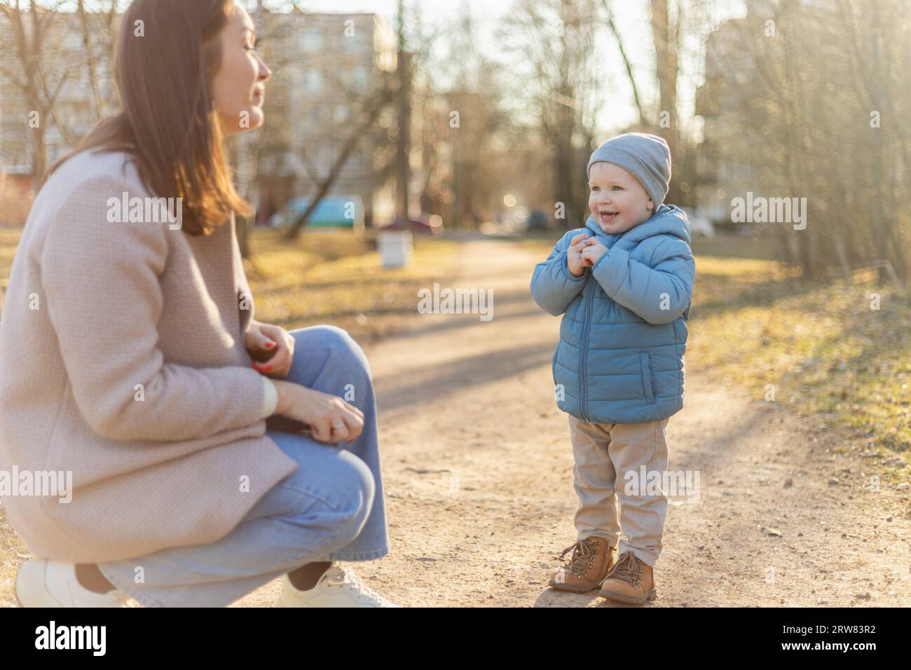 Happy family outdoor. Mother child on walk in park. Mom playing with ...