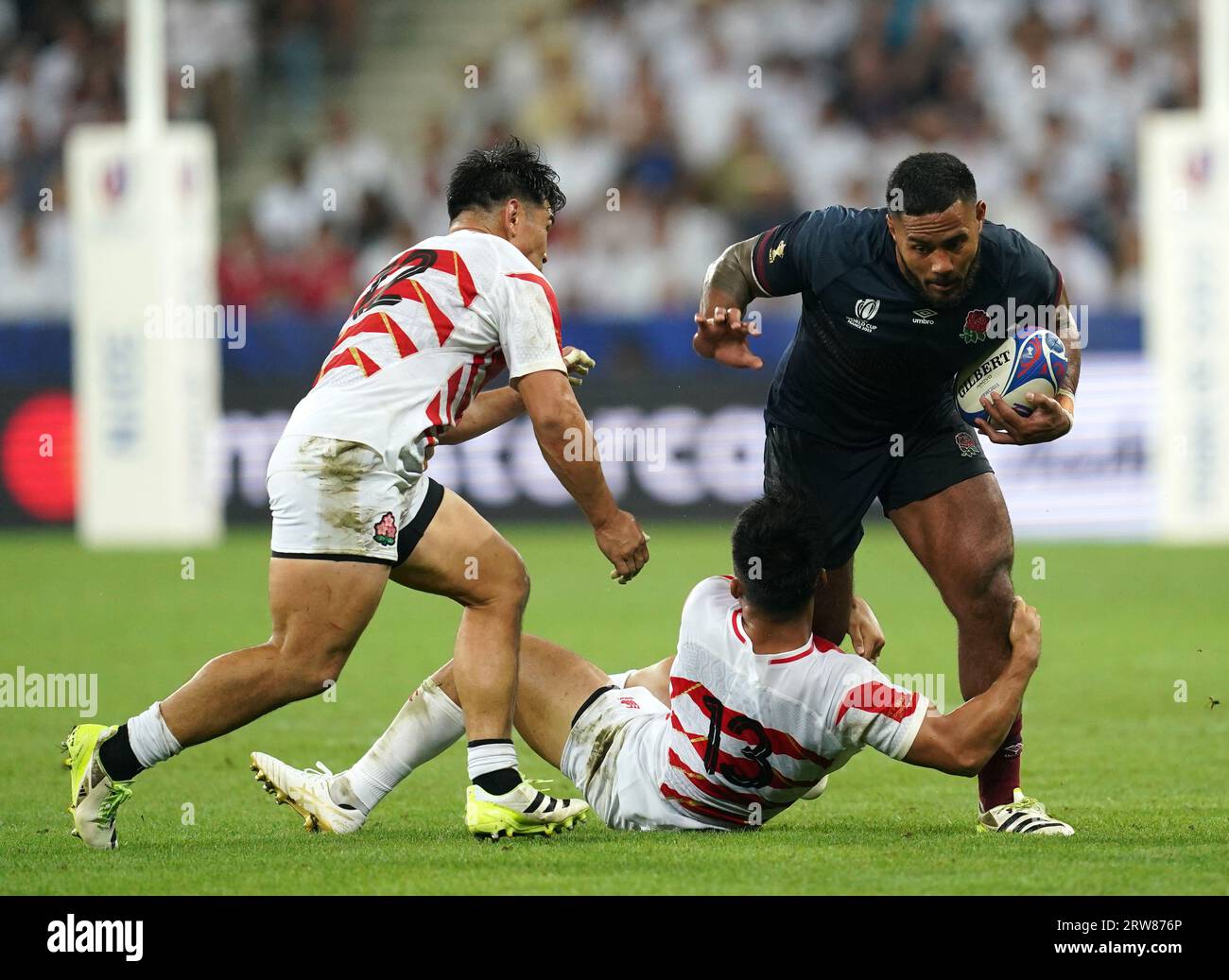 England's Manu Tuilagi (right) tackled by Japan's Ryoto Nakamura and Tomoki Osada during the ...