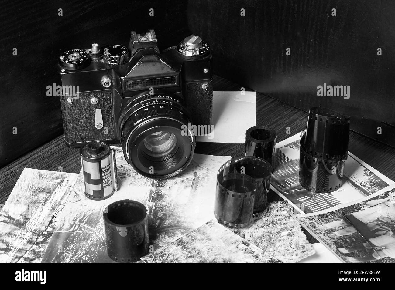 Old vintage camera, rolls of film, old photos. Tilted view, floating ...