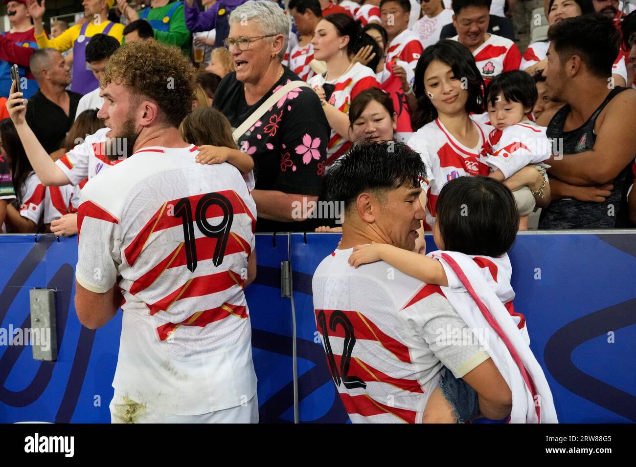 Japan's Warner Dearns, left and Japan's Ryoto Nakamura meet their families after the end of the ...