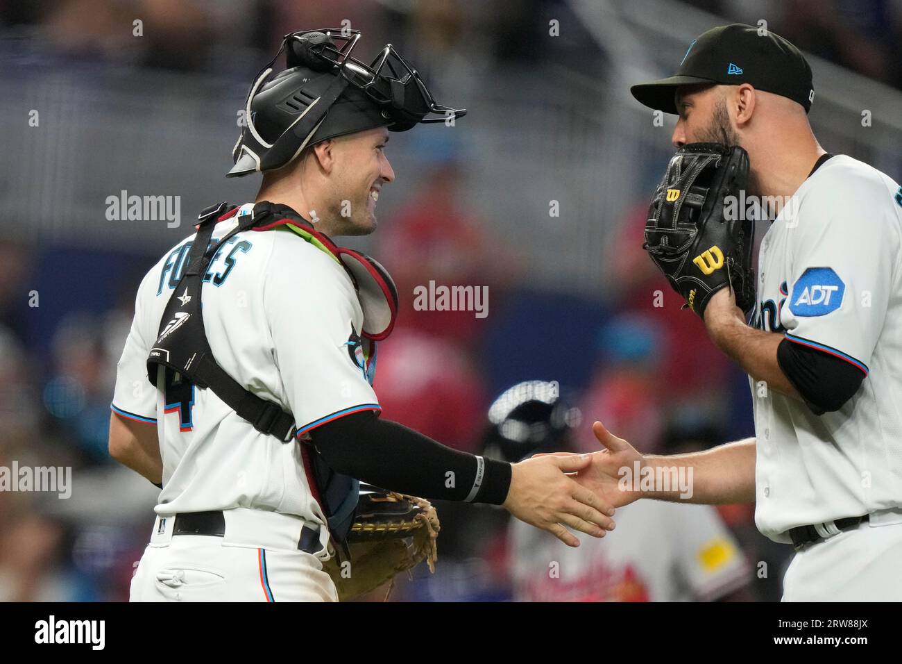 Miami Marlins catcher Nick Fortes (4) shakes hands with Jacob Stallings ...