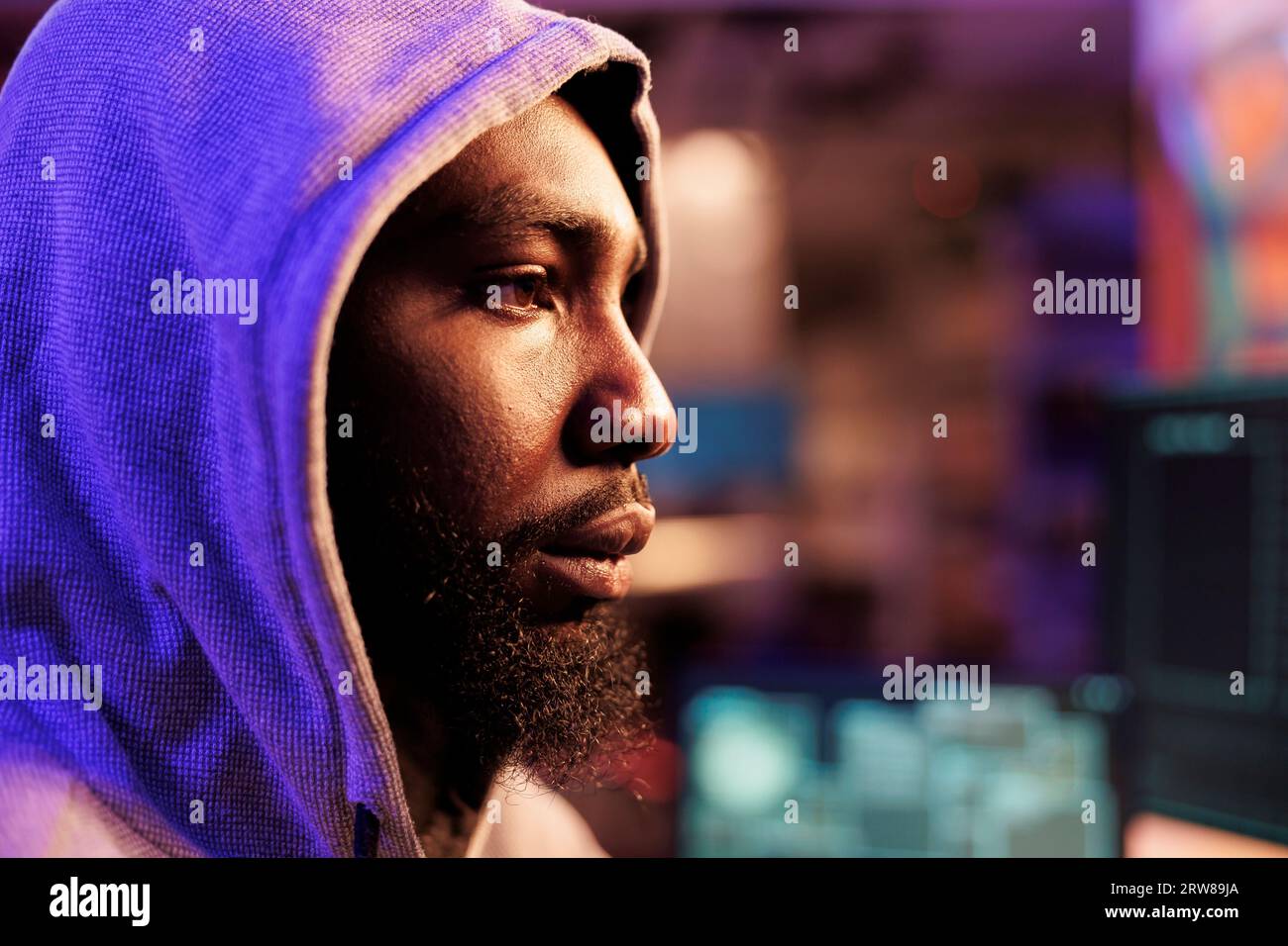 African american hacker in hood breaking into computer network system ...