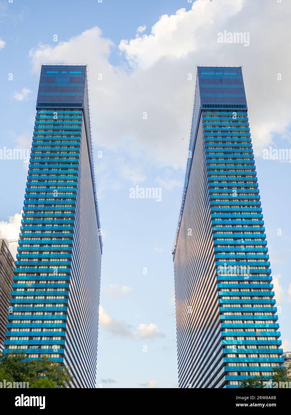Two identical high-rise buildings. Blue skyscrapers. Orbi city. Modern ...