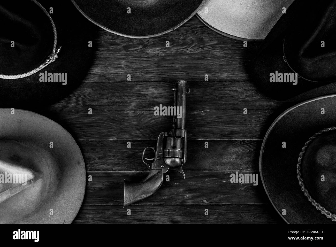 Gun with old west hats on wooden table. Top view Stock Photo - Alamy