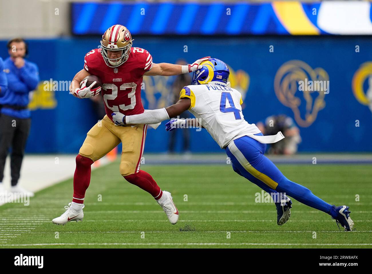 San Francisco 49ers running back Christian McCaffrey, left, fends off ...