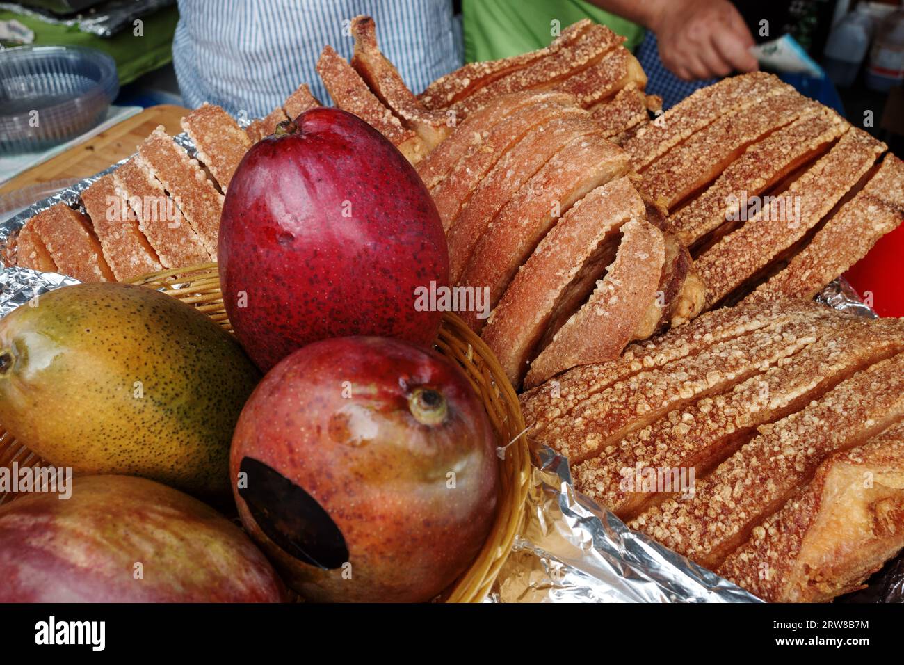 Top view, group of mangoes and crispy pork belly sell on the stall of ...