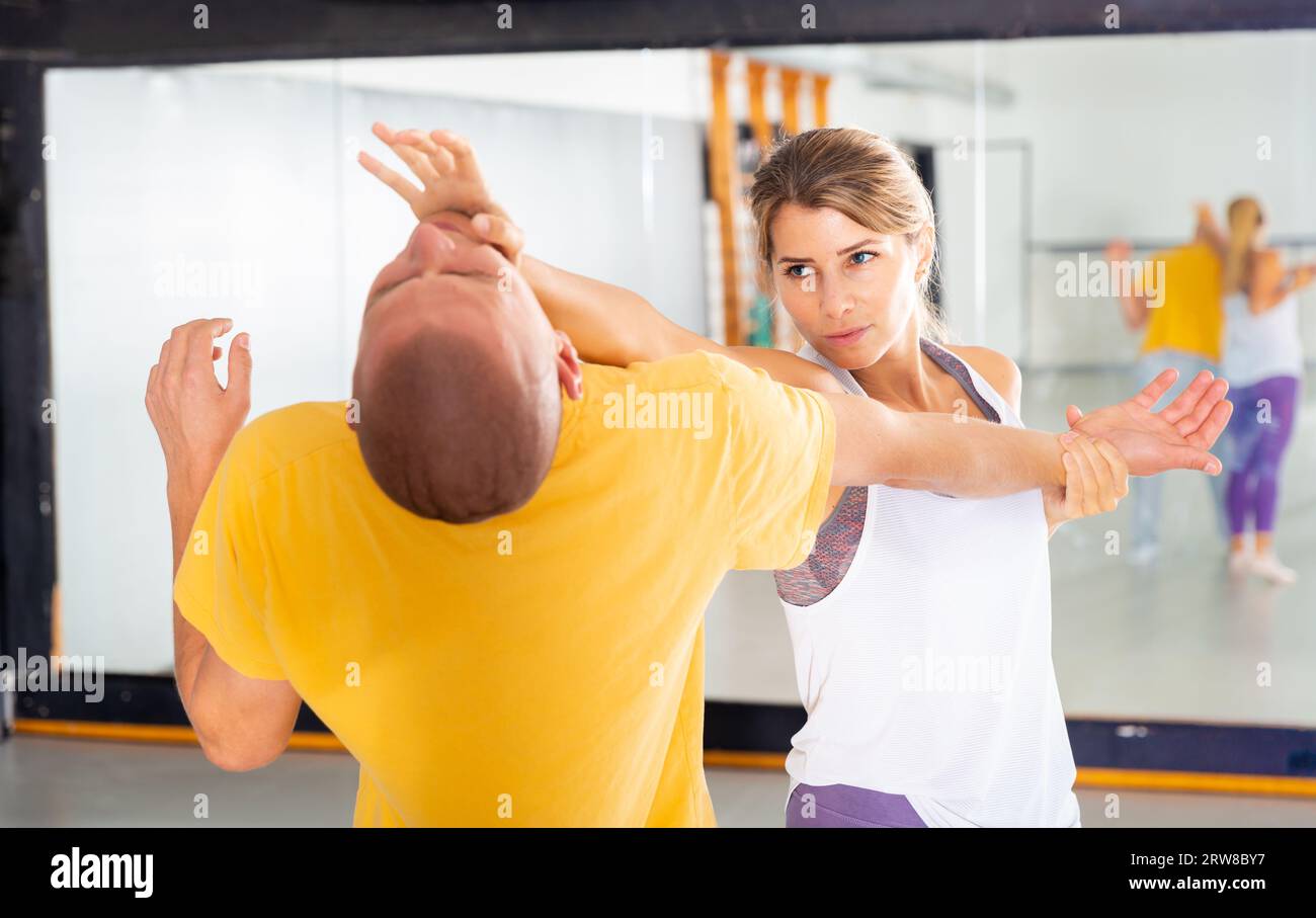 Woman performing palm heel strike while training in gym Stock Photo - Alamy