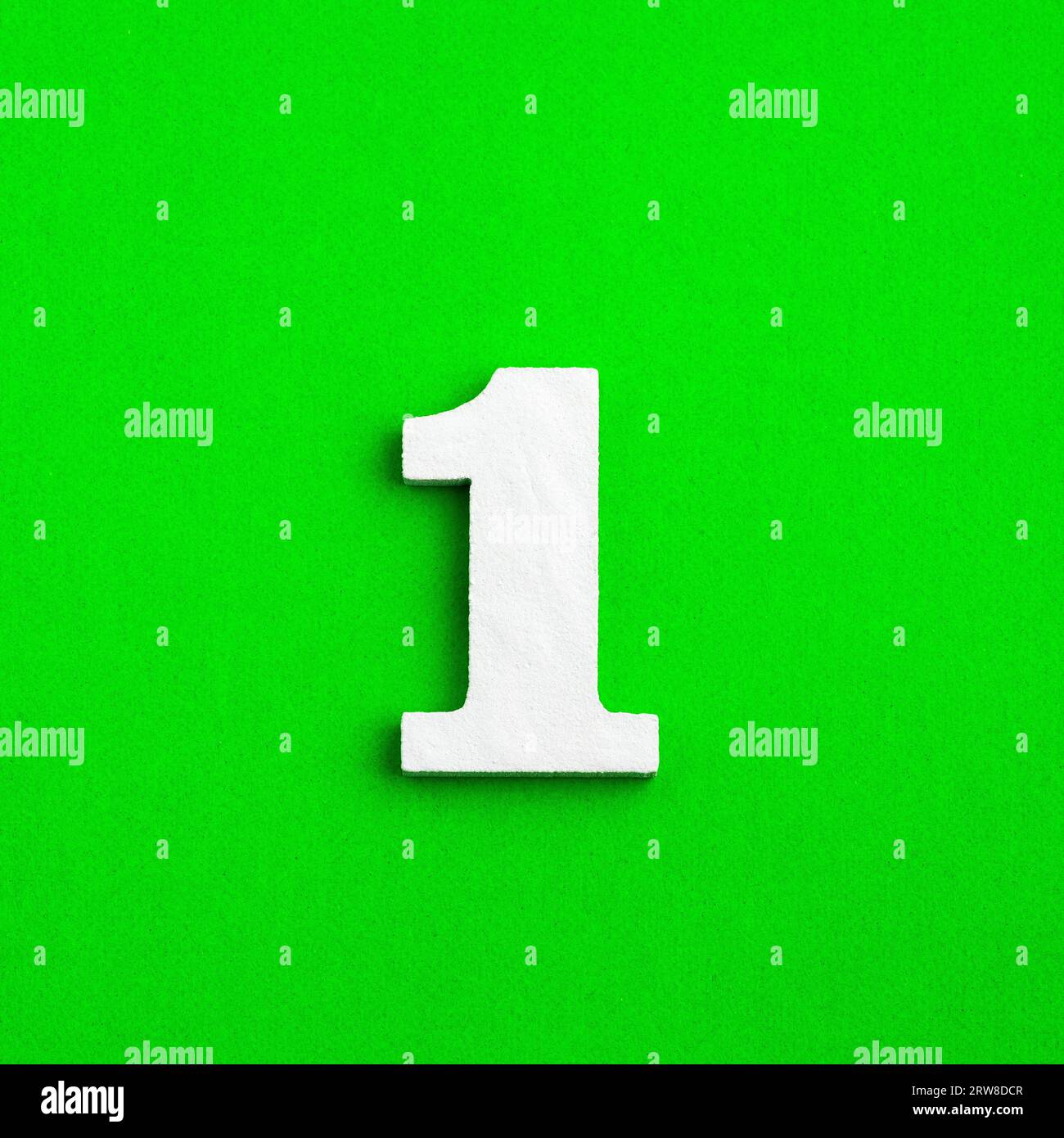 Number one - white number in wood on green background Stock Photo - Alamy