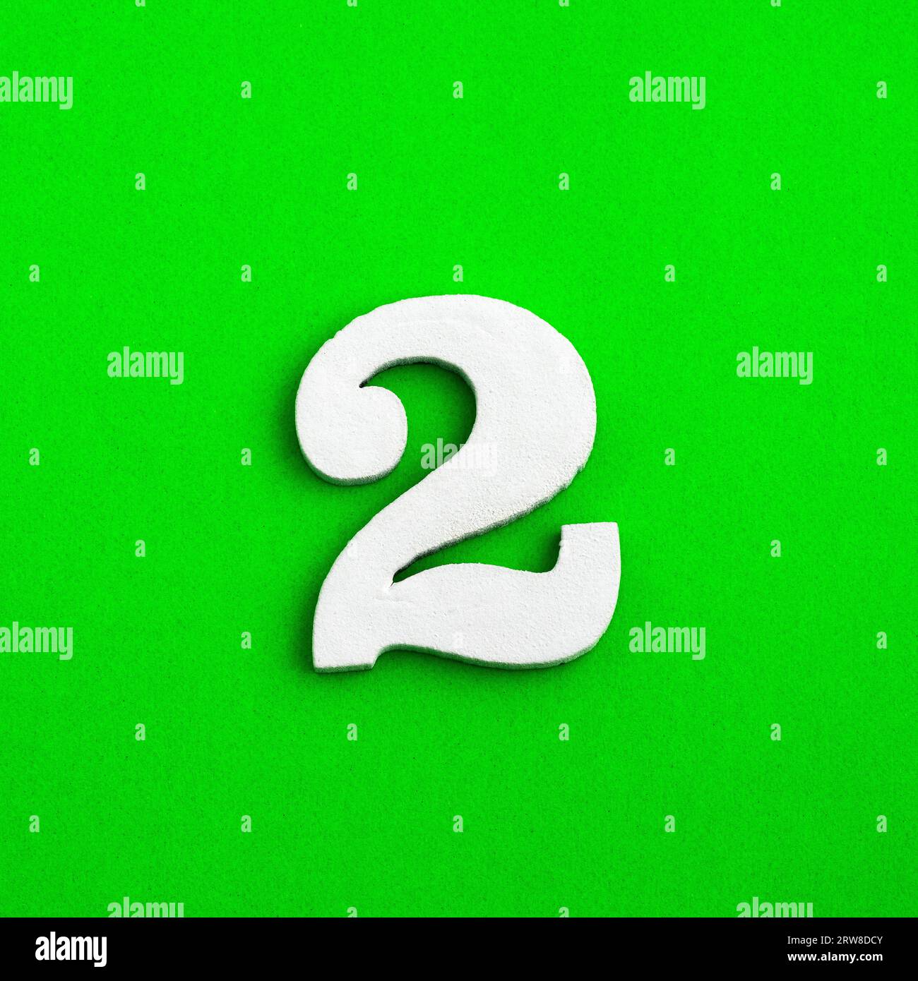Number 2 - White wooden number on green background Stock Photo - Alamy