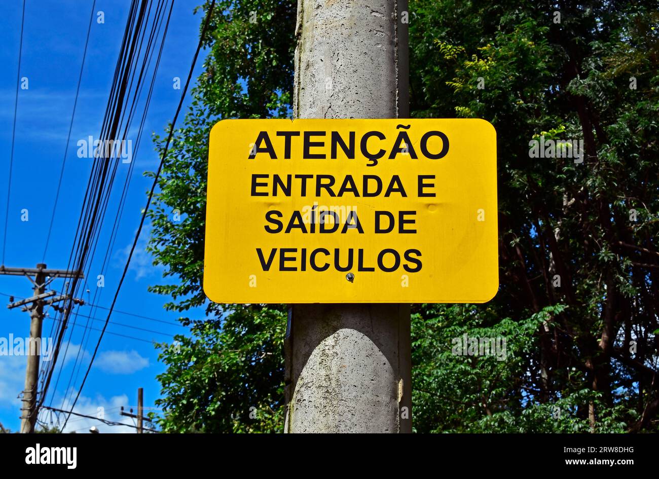 Warning sign in portuguese informing "Attention, entry and exit of ...