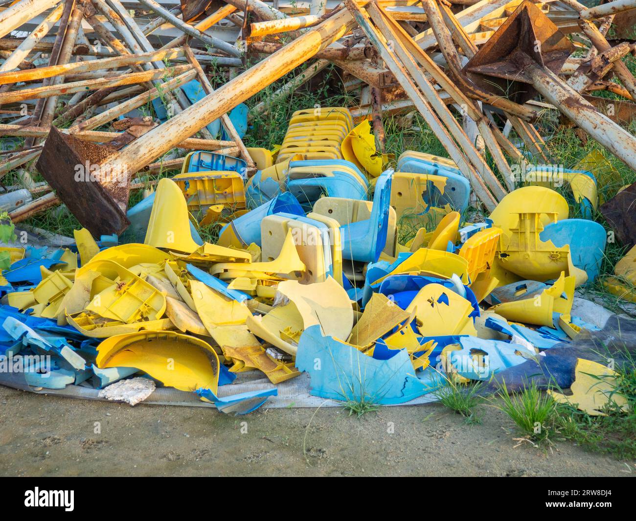 Old broken plastic chairs at the stadium. Fan riot concept. A pile of ...