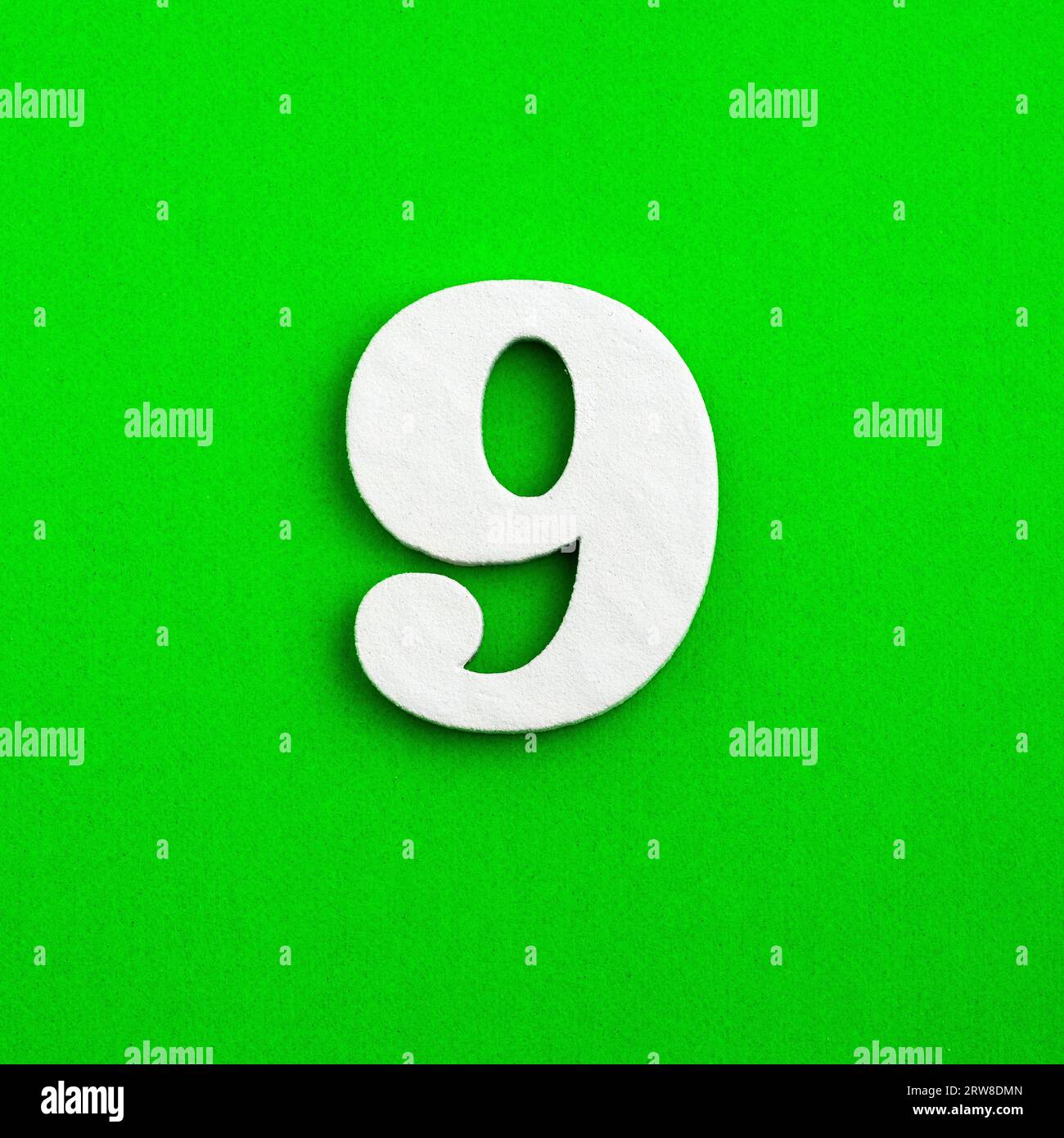 Number nine - white number in wood on green background Stock Photo - Alamy