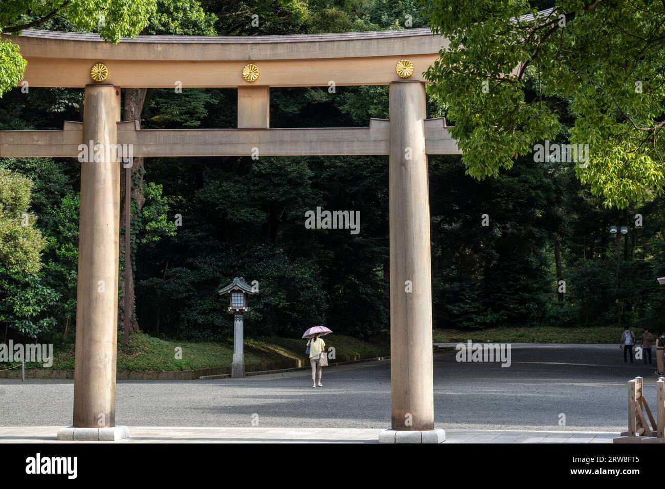 A tourist walks past the second gate Ni no torri at the Meiji Jingu ...