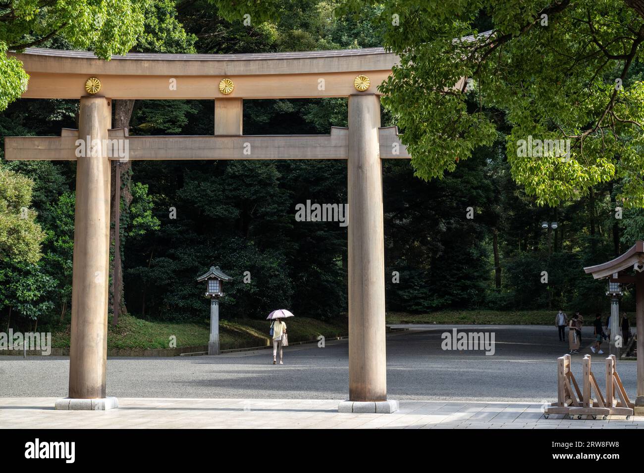 A tourist walks past the second gate Ni no torri at the Meiji Jingu ...