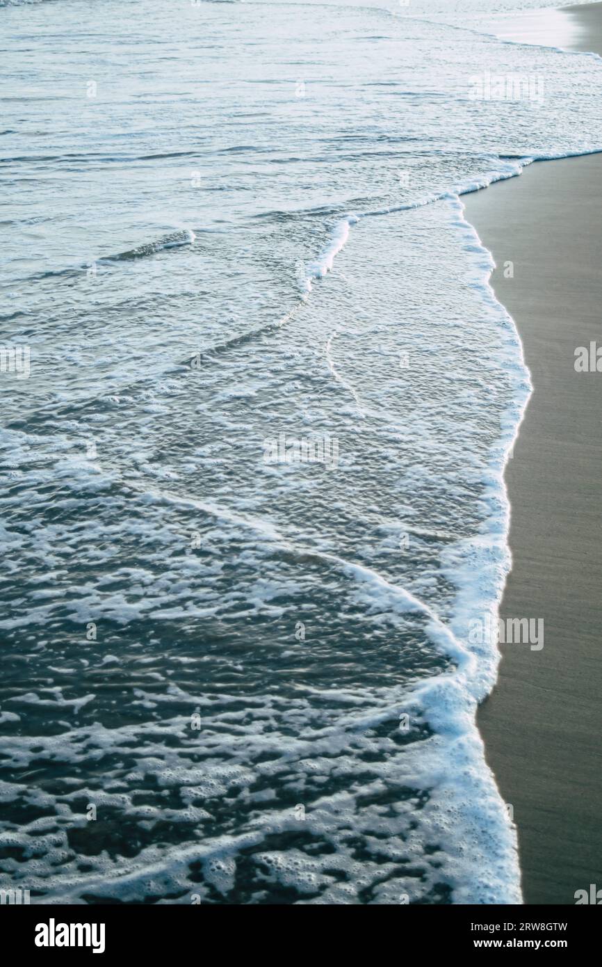 View of a wave reaching a beach Stock Photo - Alamy