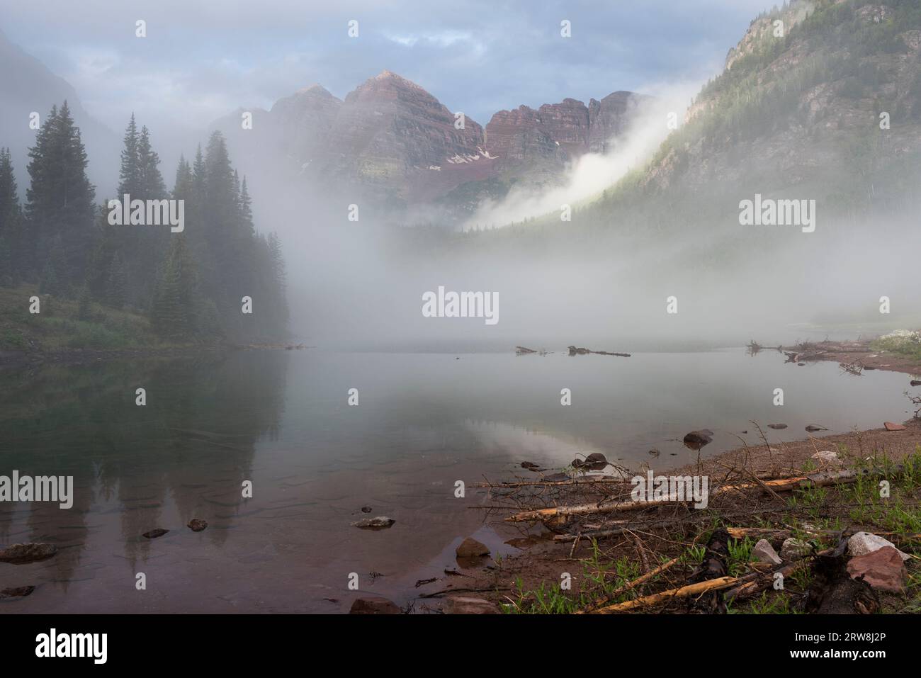 A Play of light and fog on the Maroon Bells with a reflection on Maroon ...
