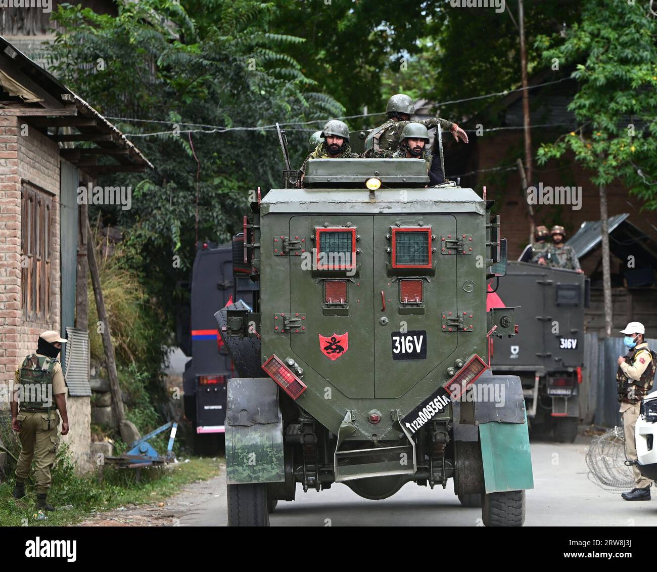 SRINAGAR, INDIA - SEPTEMBER 17: Army soldiers in an armoured vehicle as ...