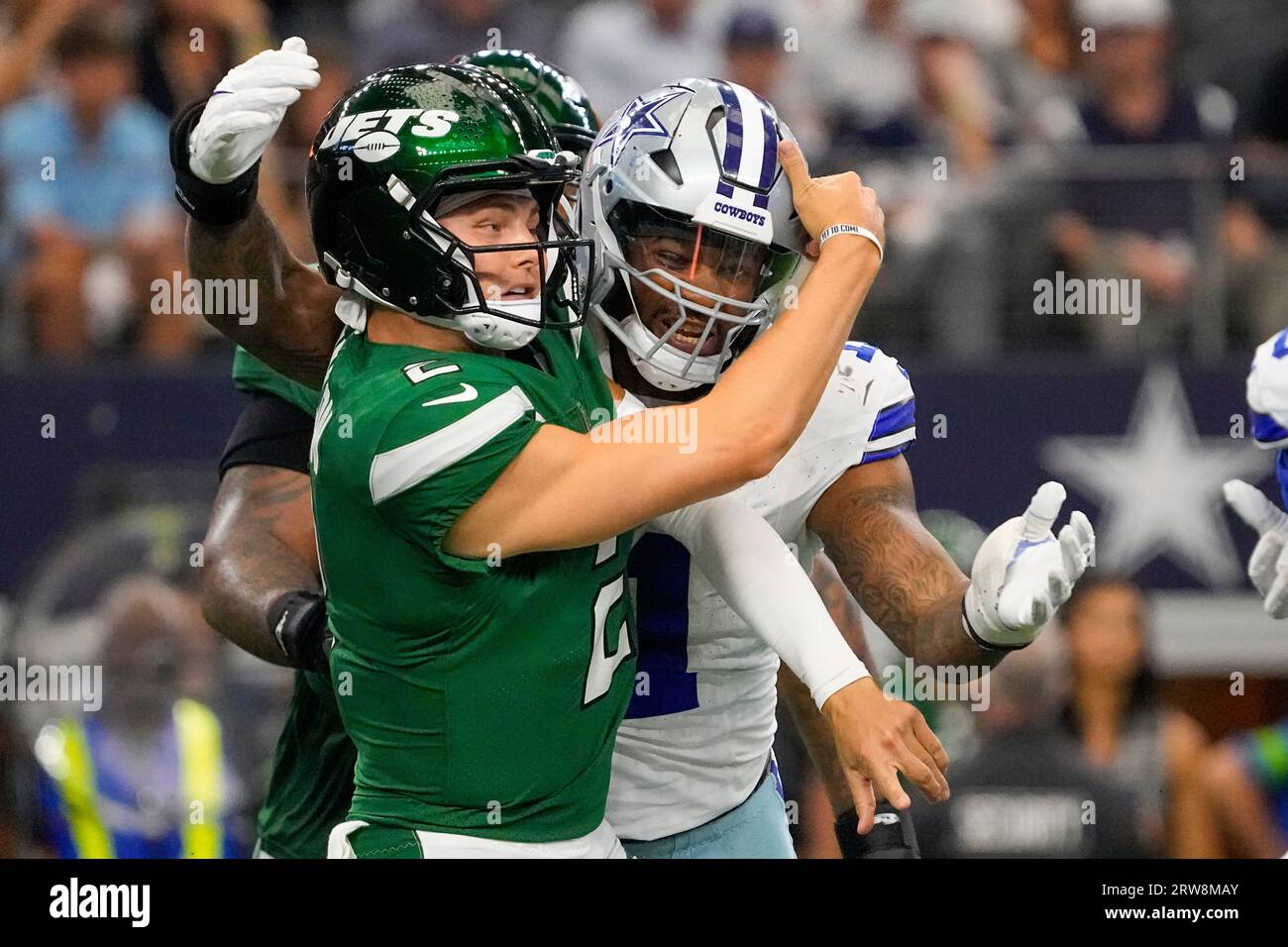 New York Jets quarterback Zach Wilson gets off a pass under pressure ...