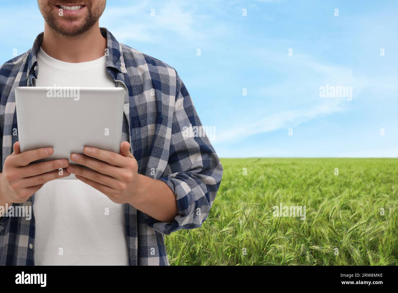 Farmer with tablet computer in field, closeup. Harvesting season Stock ...