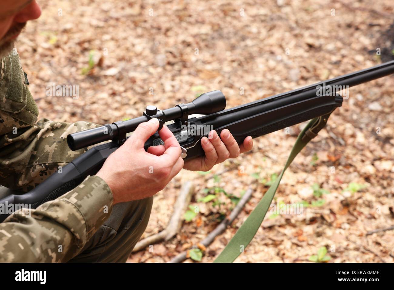 Man with hunting rifle wearing camouflage outdoors, closeup Stock Photo ...
