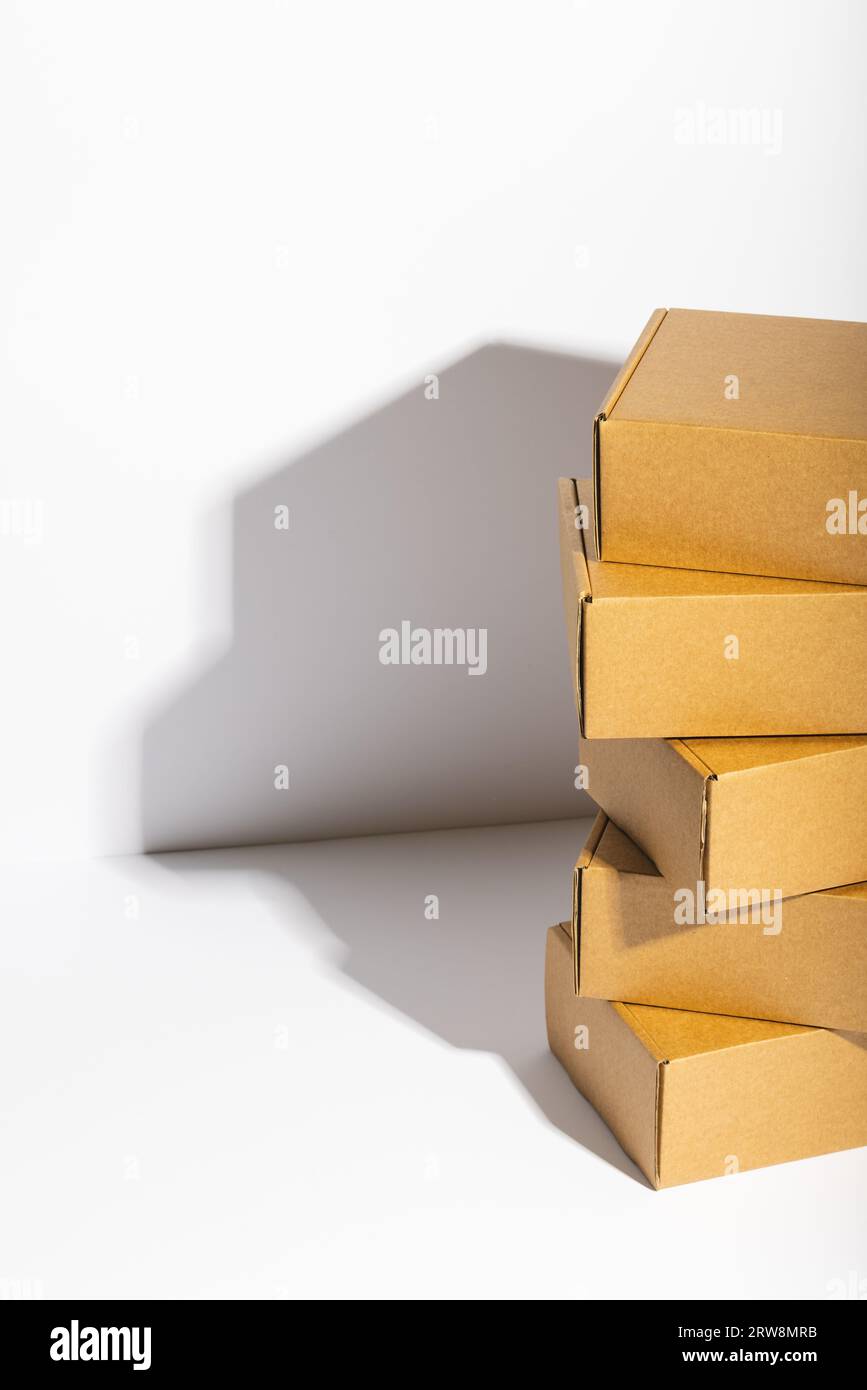 Vertical image of stack of cardboard gift boxes with copy space over ...