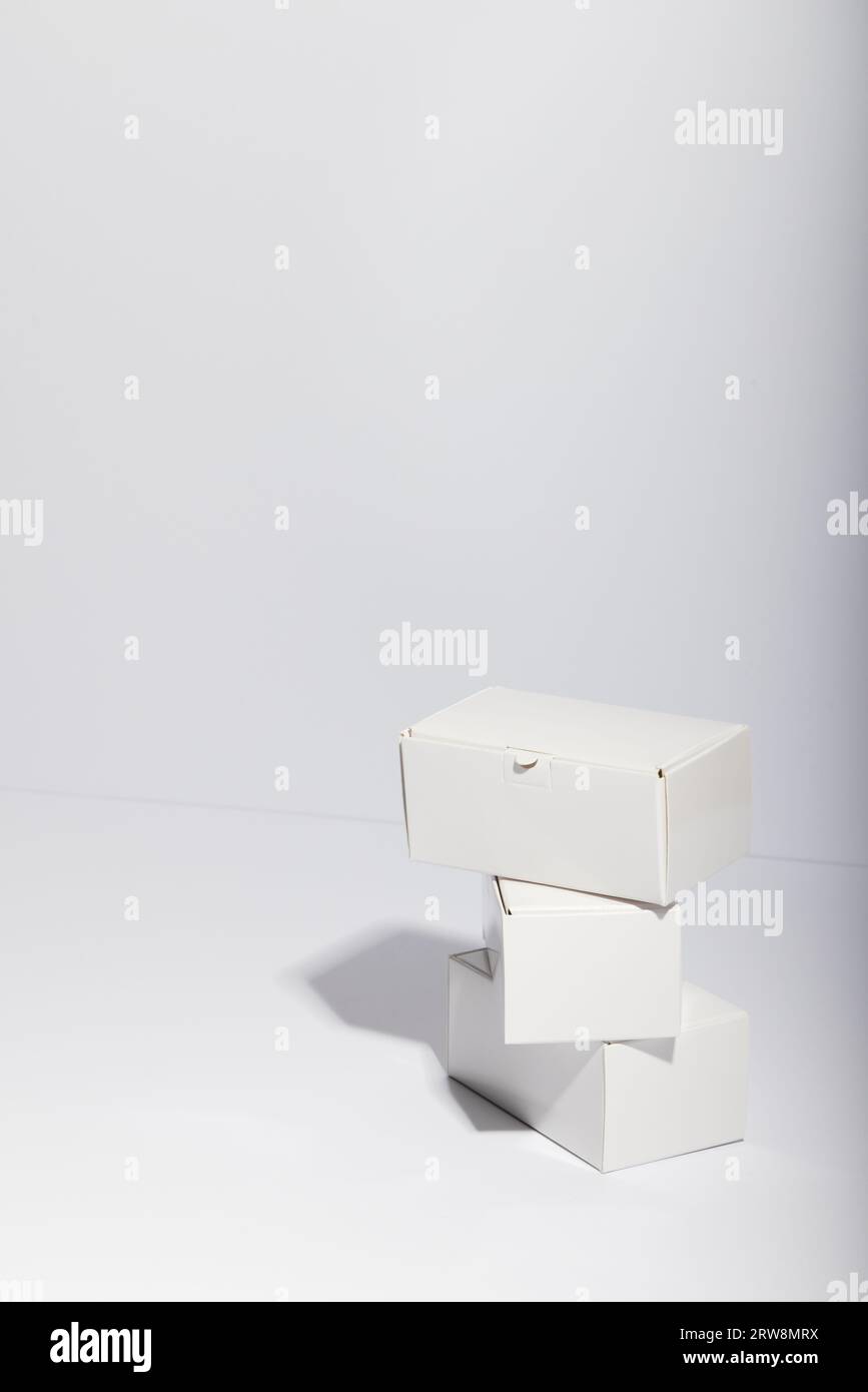 Vertical image of stack of cardboard gift boxes with copy space over ...