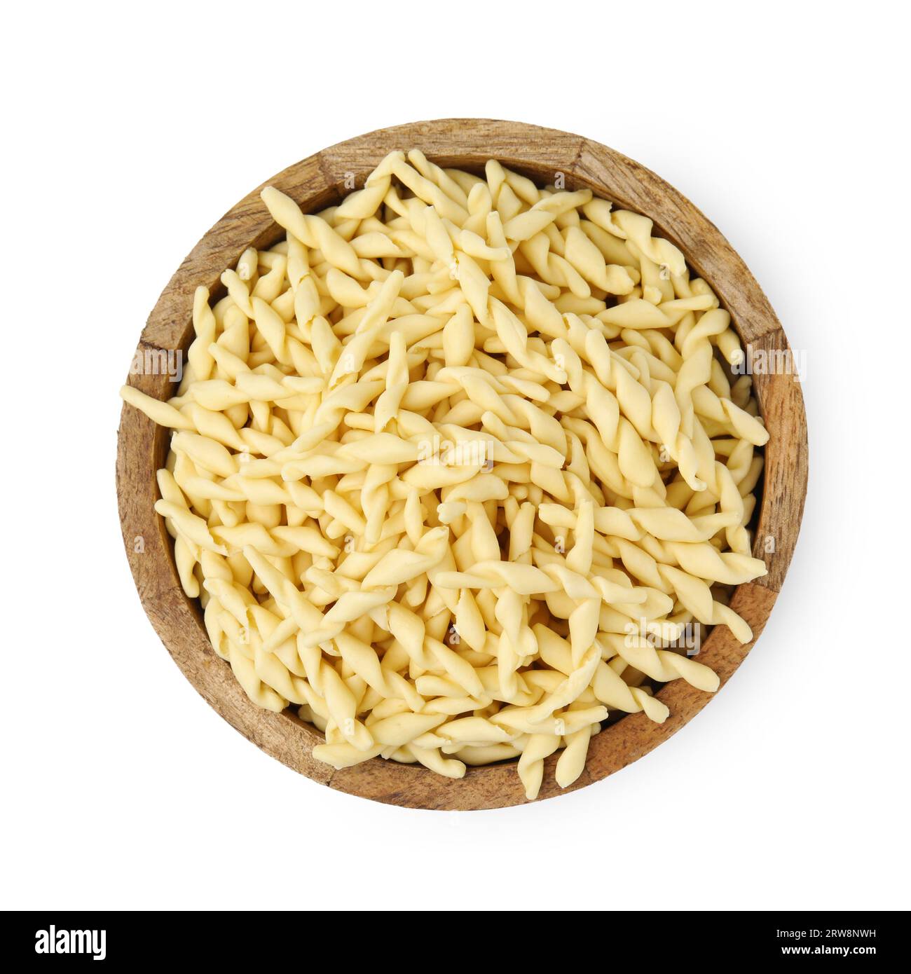 Uncooked trofie pasta in bowl isolated on white, top view Stock Photo ...