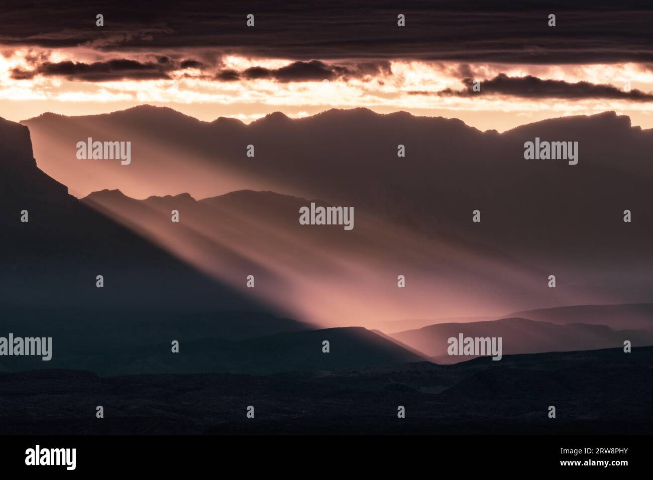 Pink Rays Of Sun Shine Through Fog And Clouds Below The Sierra Del