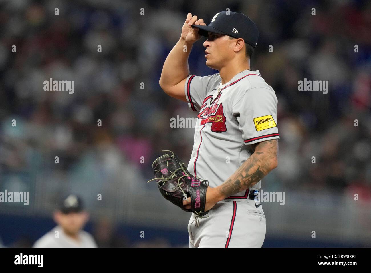 Atlanta Braves relief pitcher Dereck Rodriguez adjusts his cap on the ...