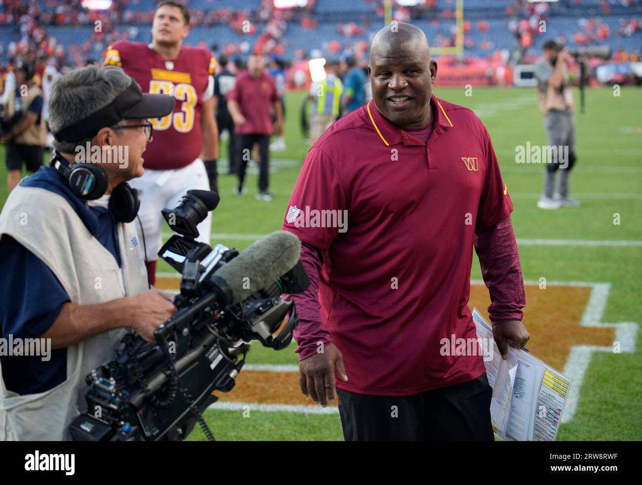 Washington Commanders offensive coordinator Eric Bieniemy, right, talks ...