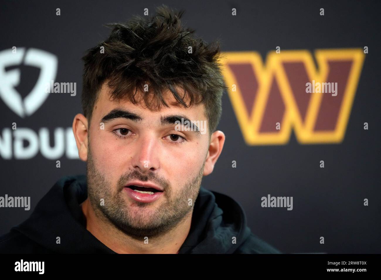 Washington Commanders quarterback Sam Howell answers questions after an ...