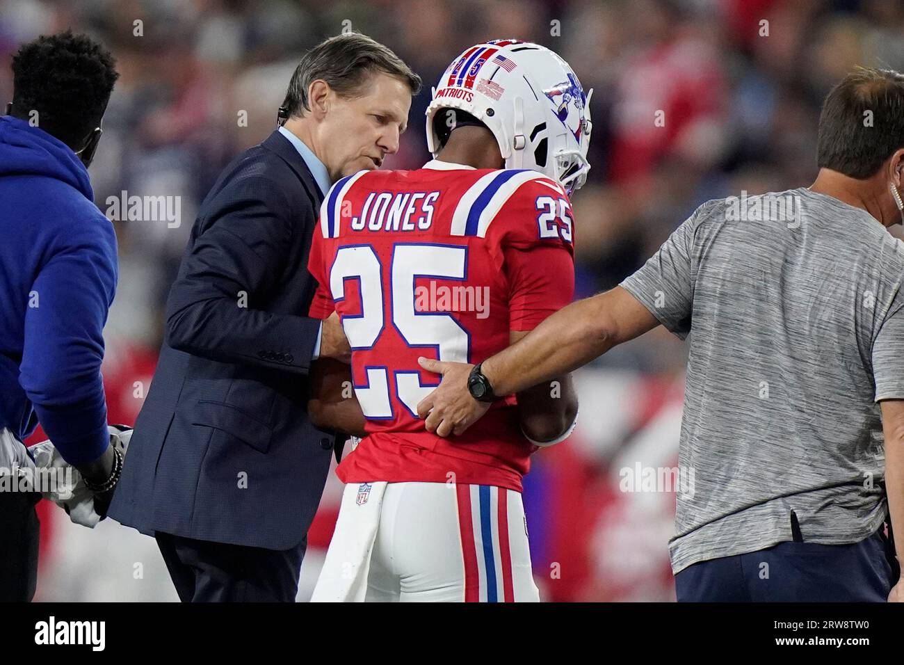 New England Patriots cornerback Marcus Jones (25) is escorted off the ...