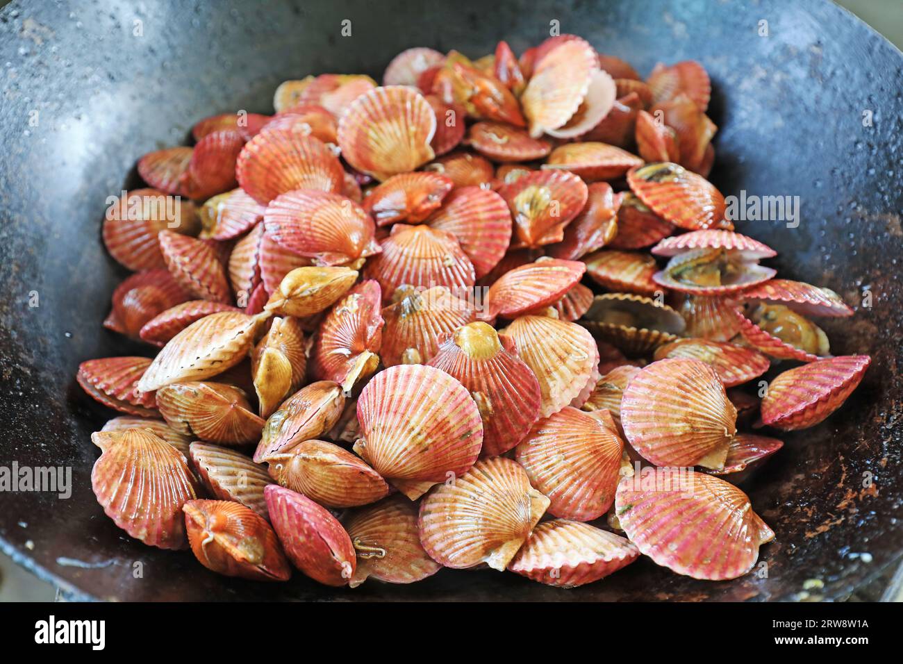 Scallops cooked in an iron pot in a restaurant, North China Stock Photo ...