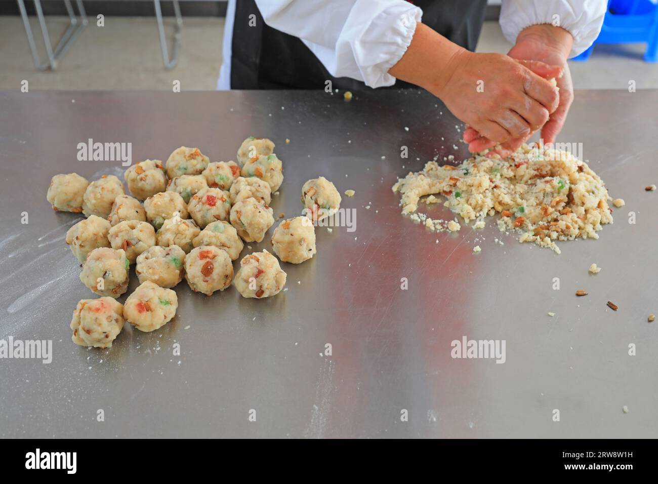 Workers are making moon cake stuffing by hand in a food processing ...