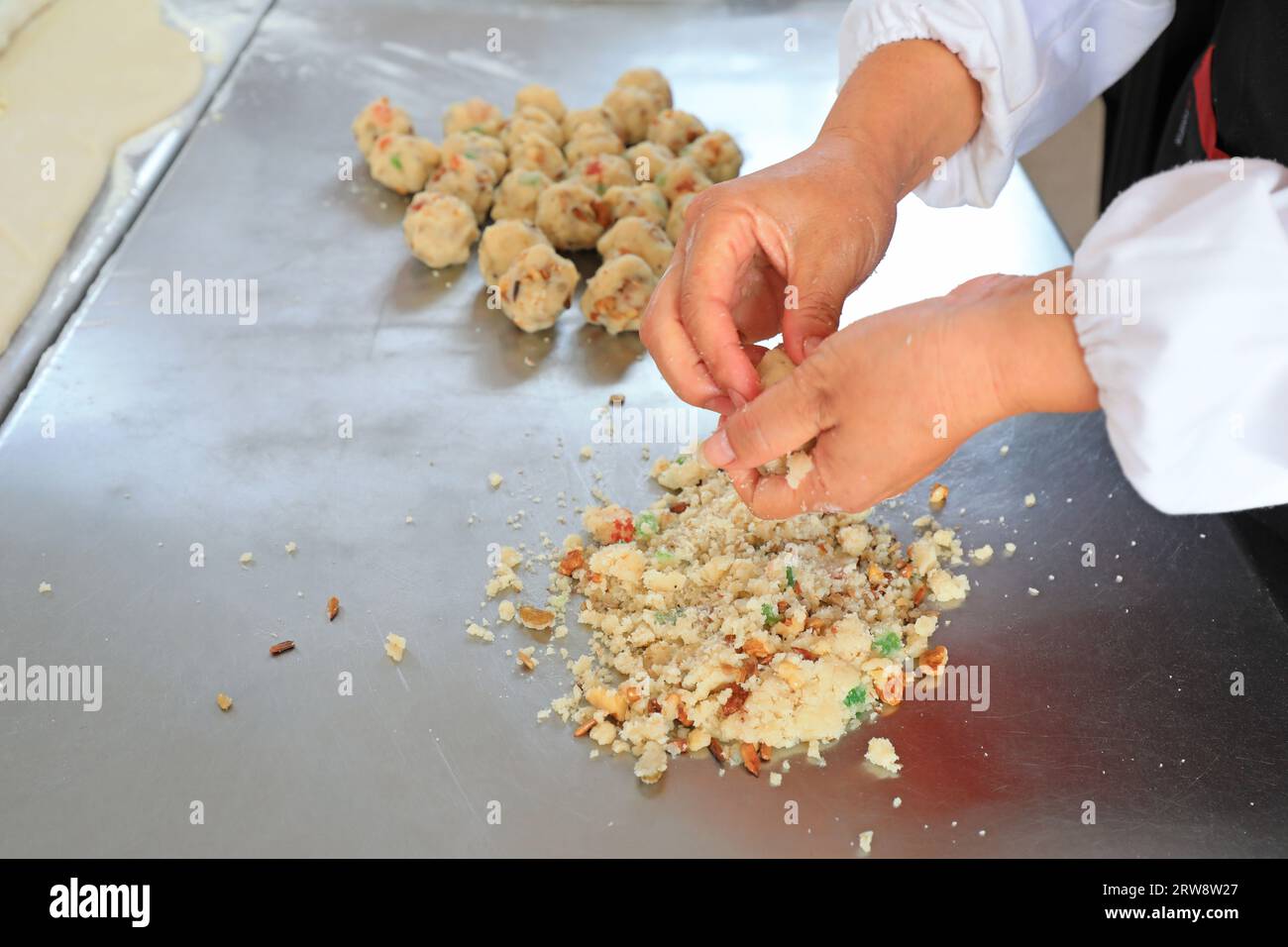 Workers are making moon cake stuffing by hand in a food processing ...