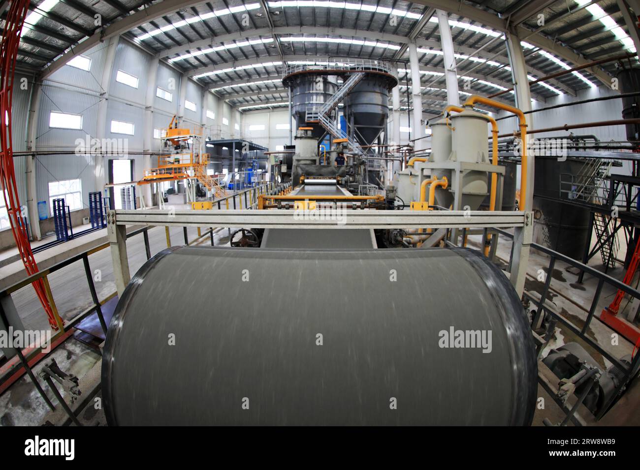 workers operate the distributor on the calcium silicate board ...